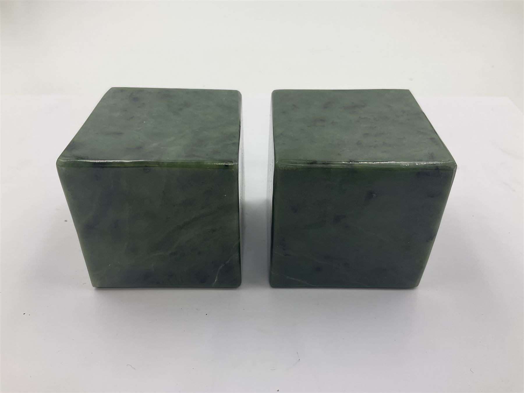 Pair of cube jade mineral specimens, each cut and polished to highlight ...