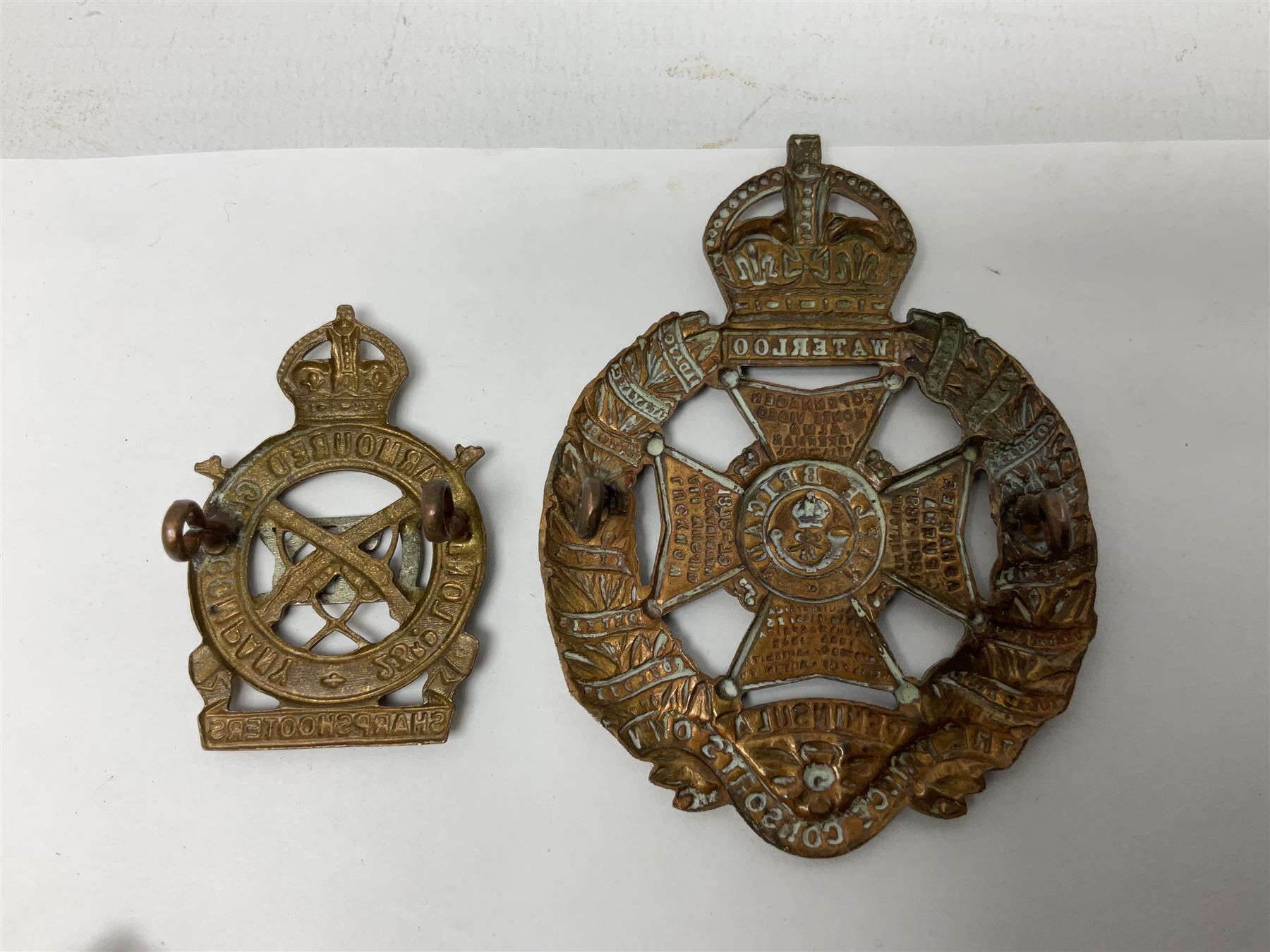 Twenty various cap badges including Rifle Brigade, Machine Gun Corps ...