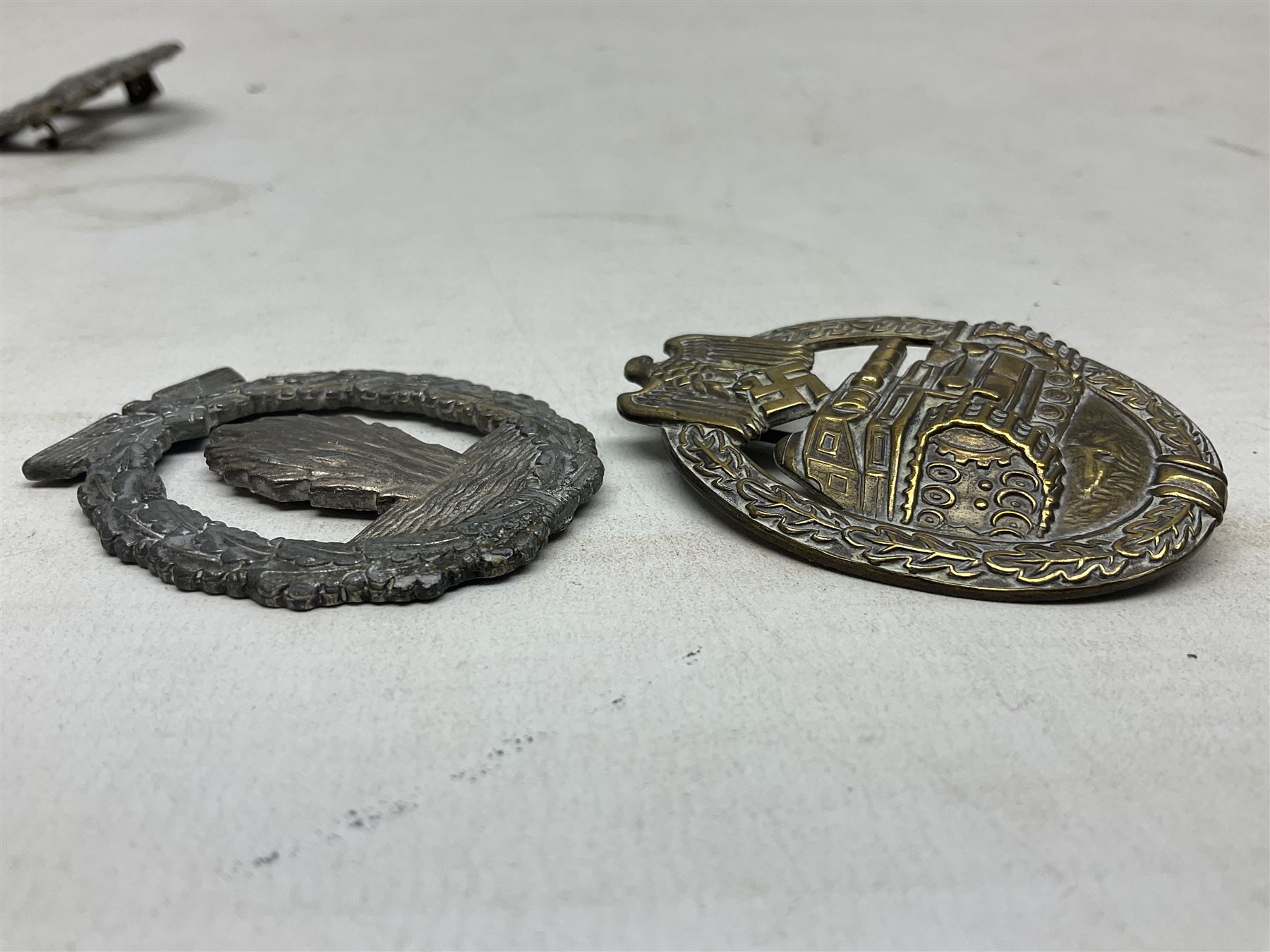 Four German badges comprising Infantry Assault badge; two Tank Battle ...