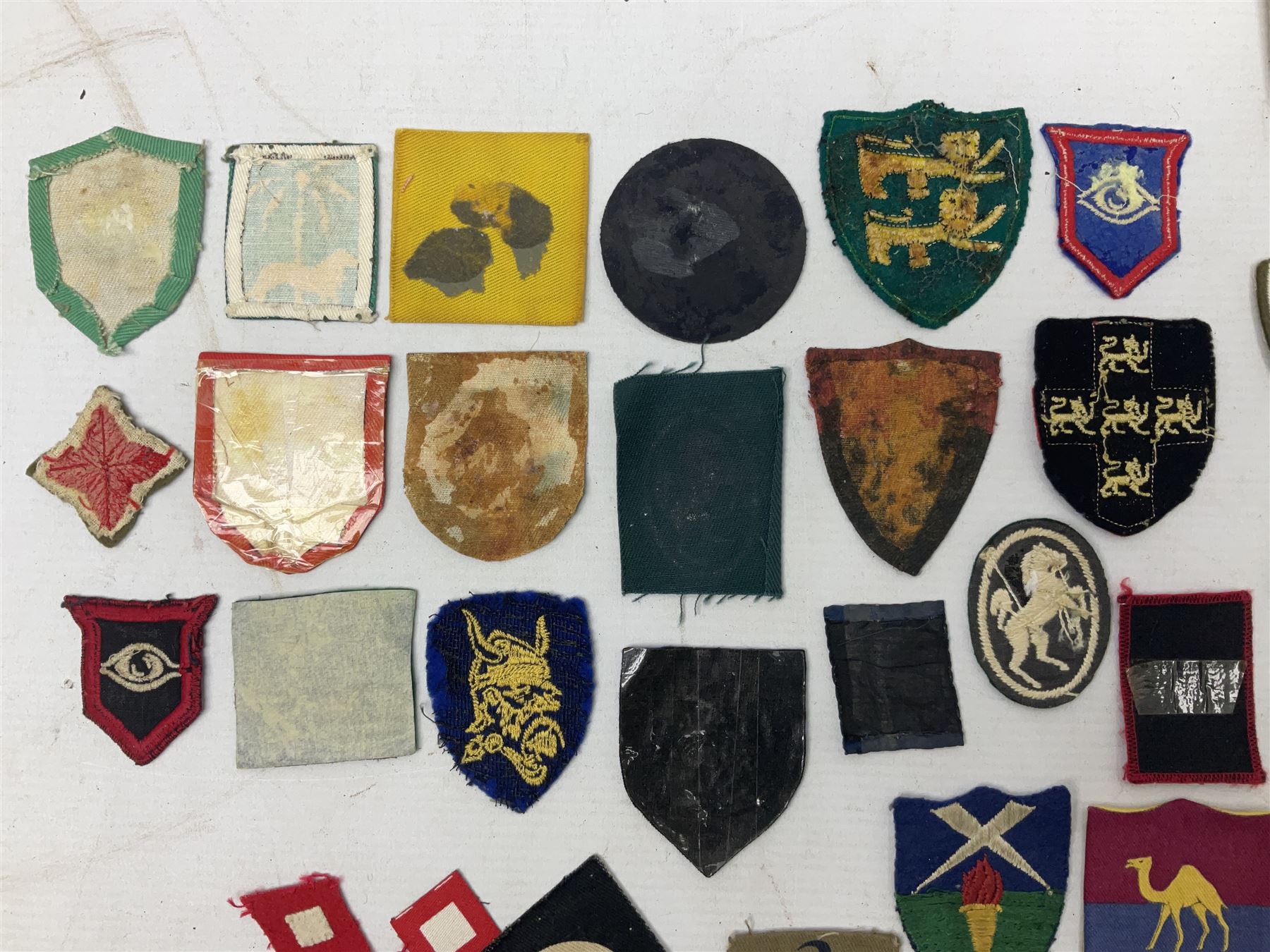 Approximately one-hundred printed and embroidered cloth badges ...