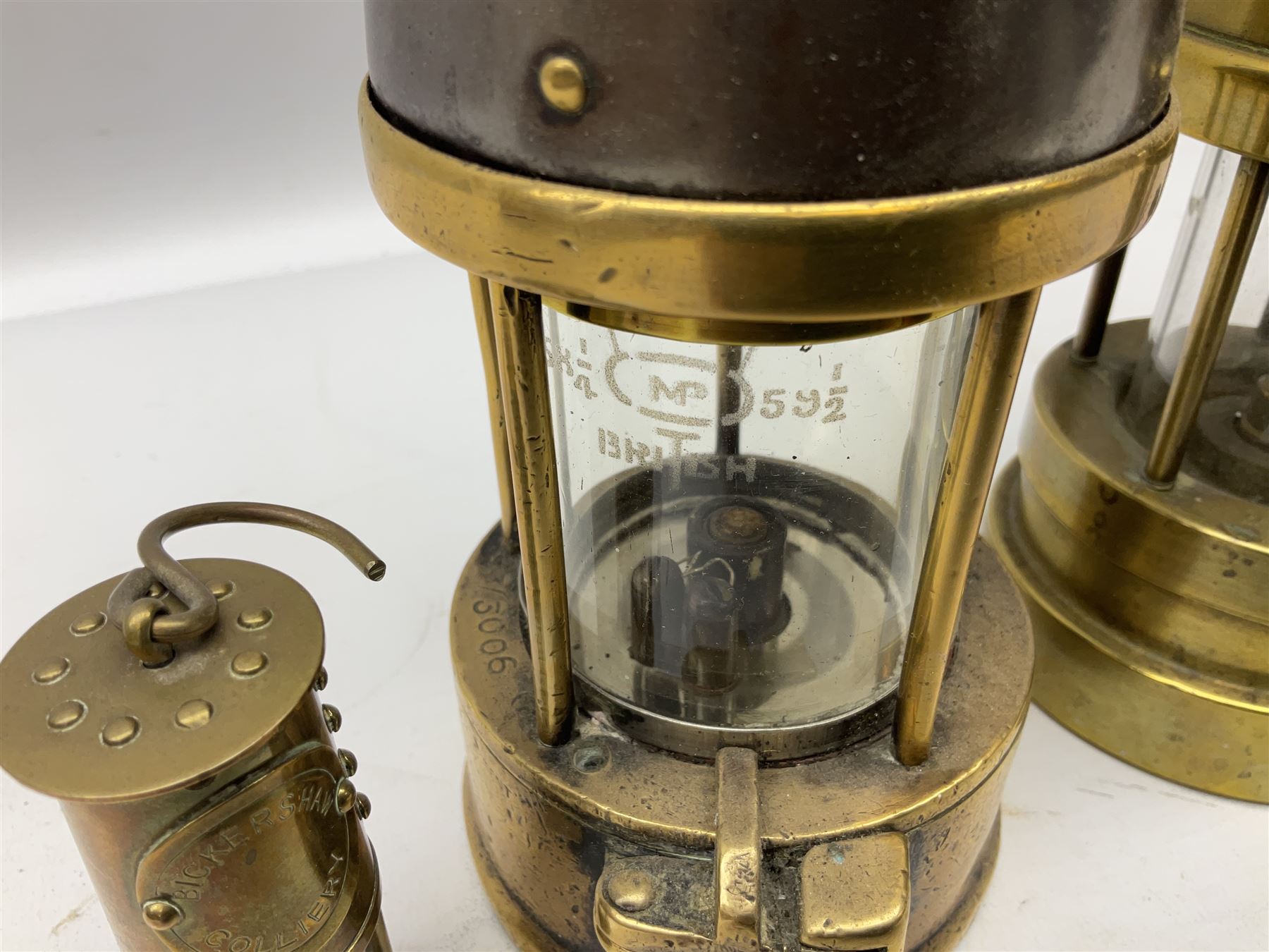 Two brass miners lamps to include an Eccles Manchester Type 6 example ...