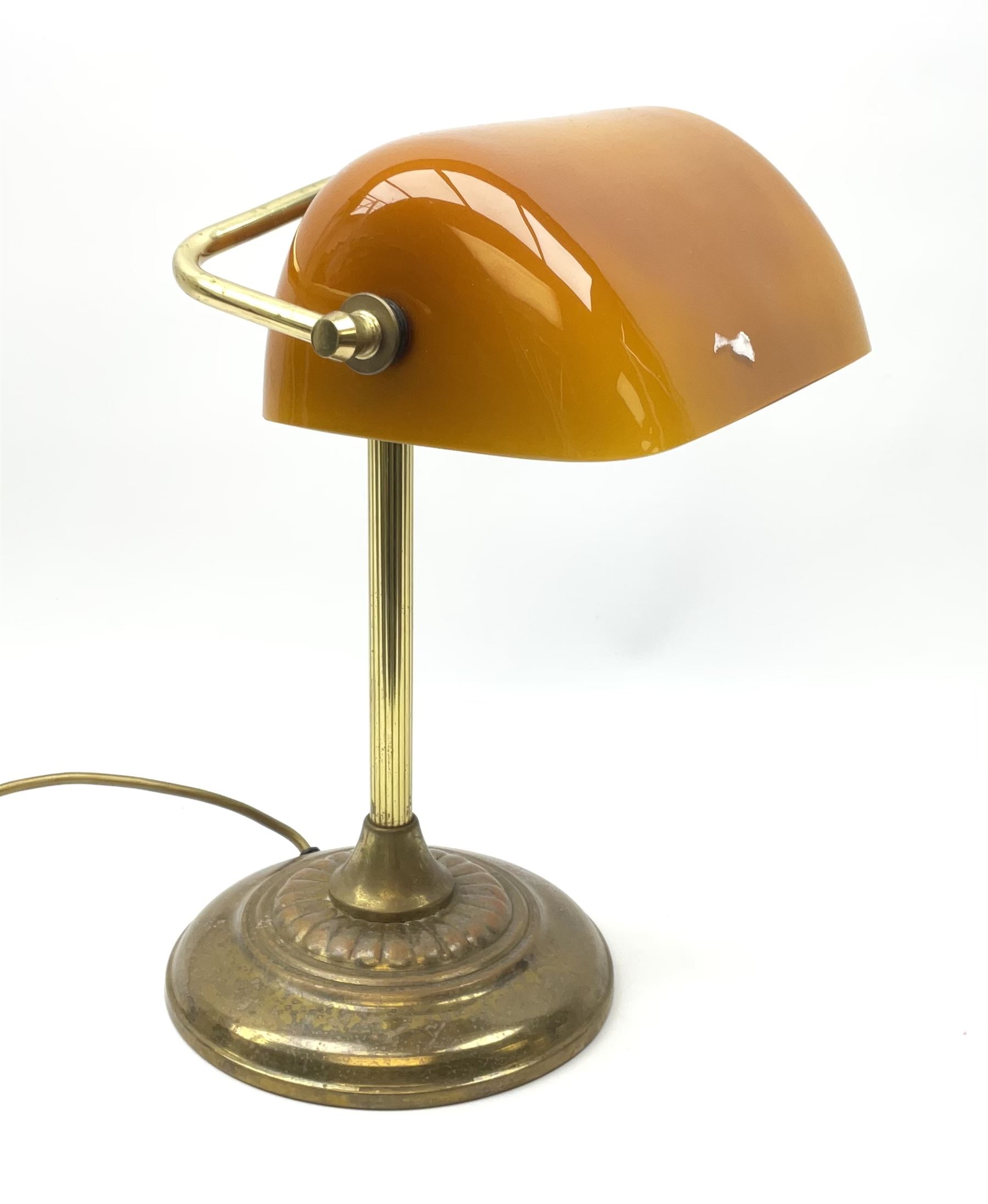 A brassed bankers lamp with spreading circular base and yellow glass ...