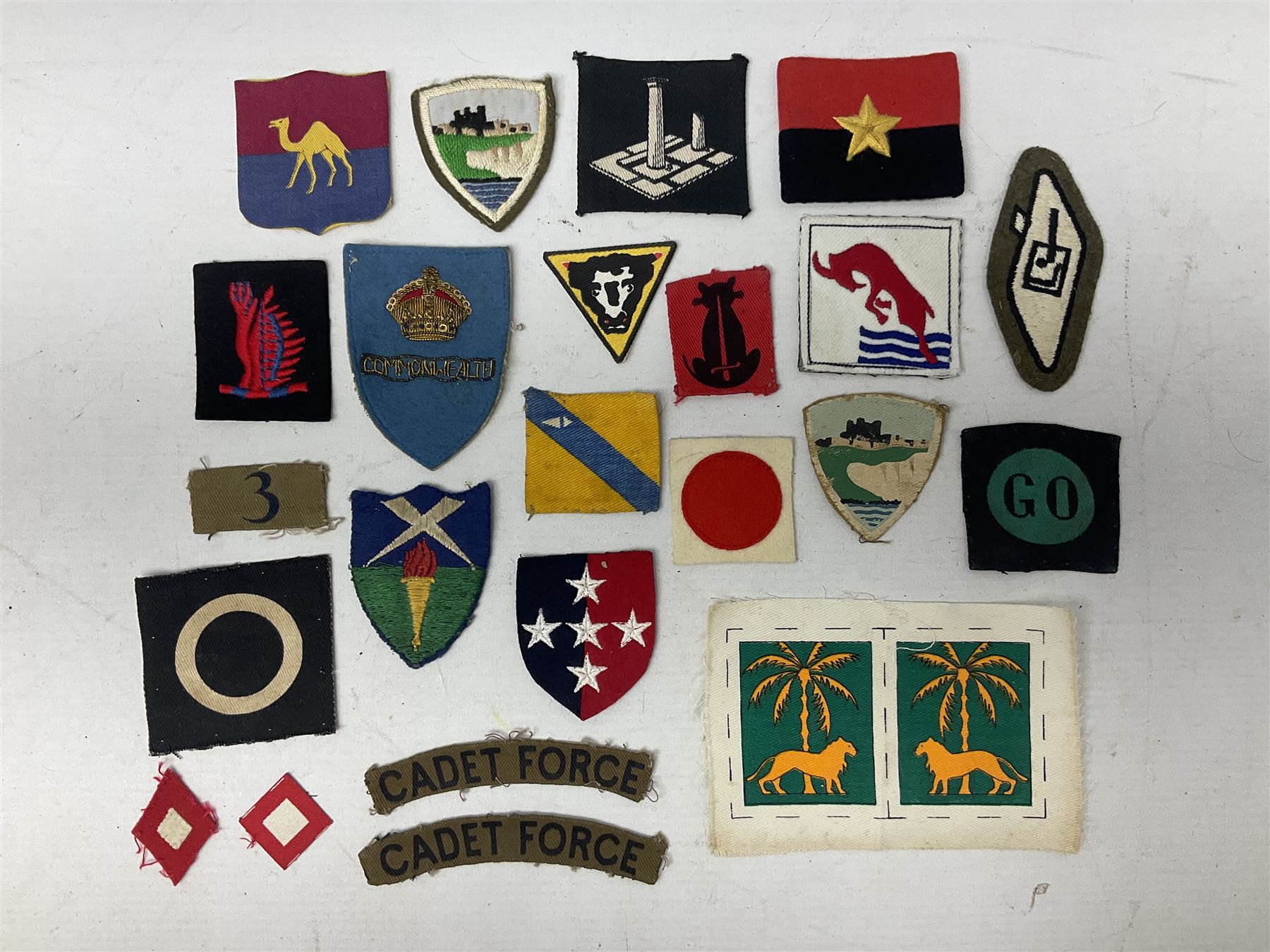Approximately one-hundred printed and embroidered cloth badges ...