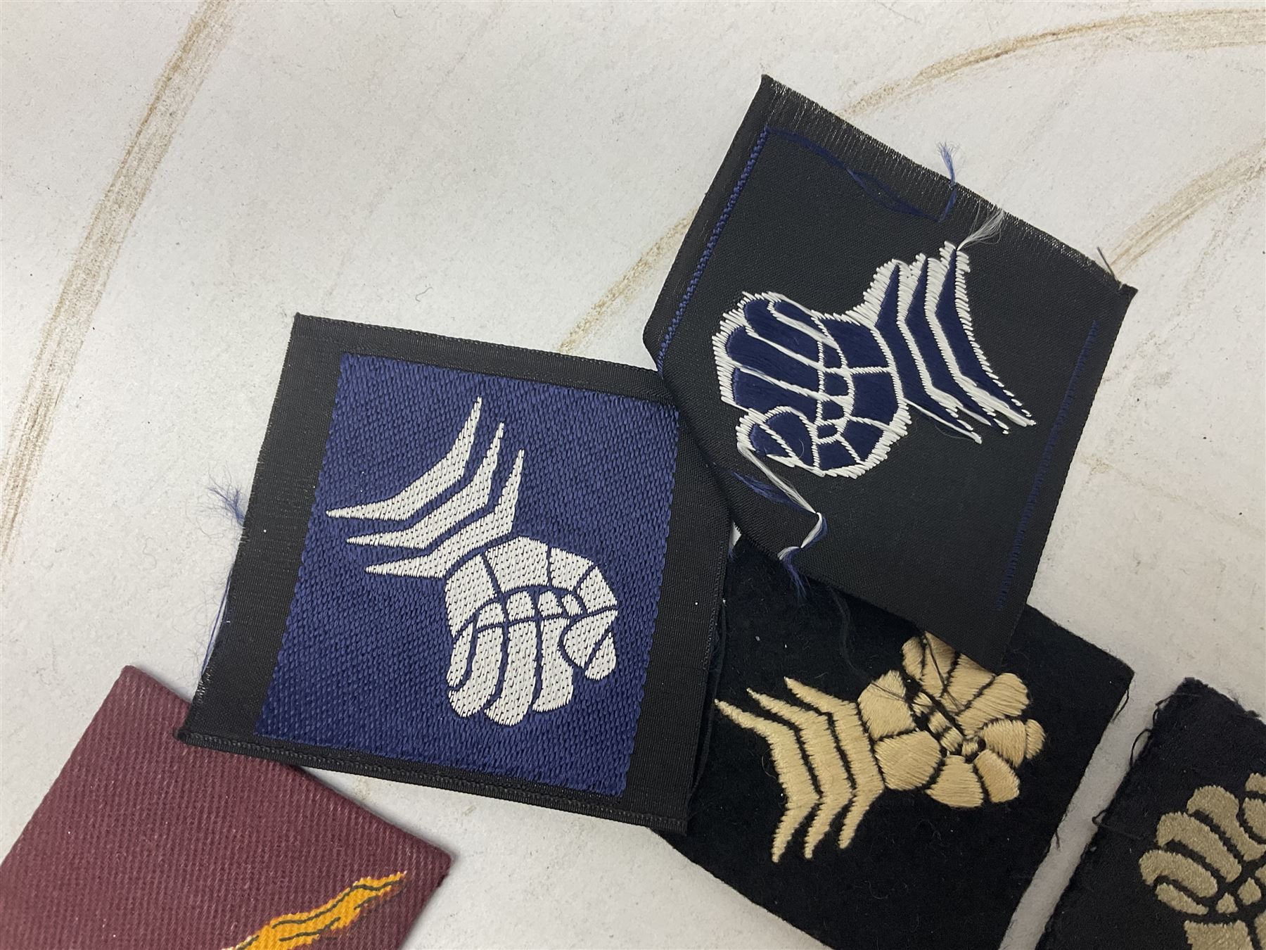 Approximately one-hundred printed and embroidered cloth badges ...