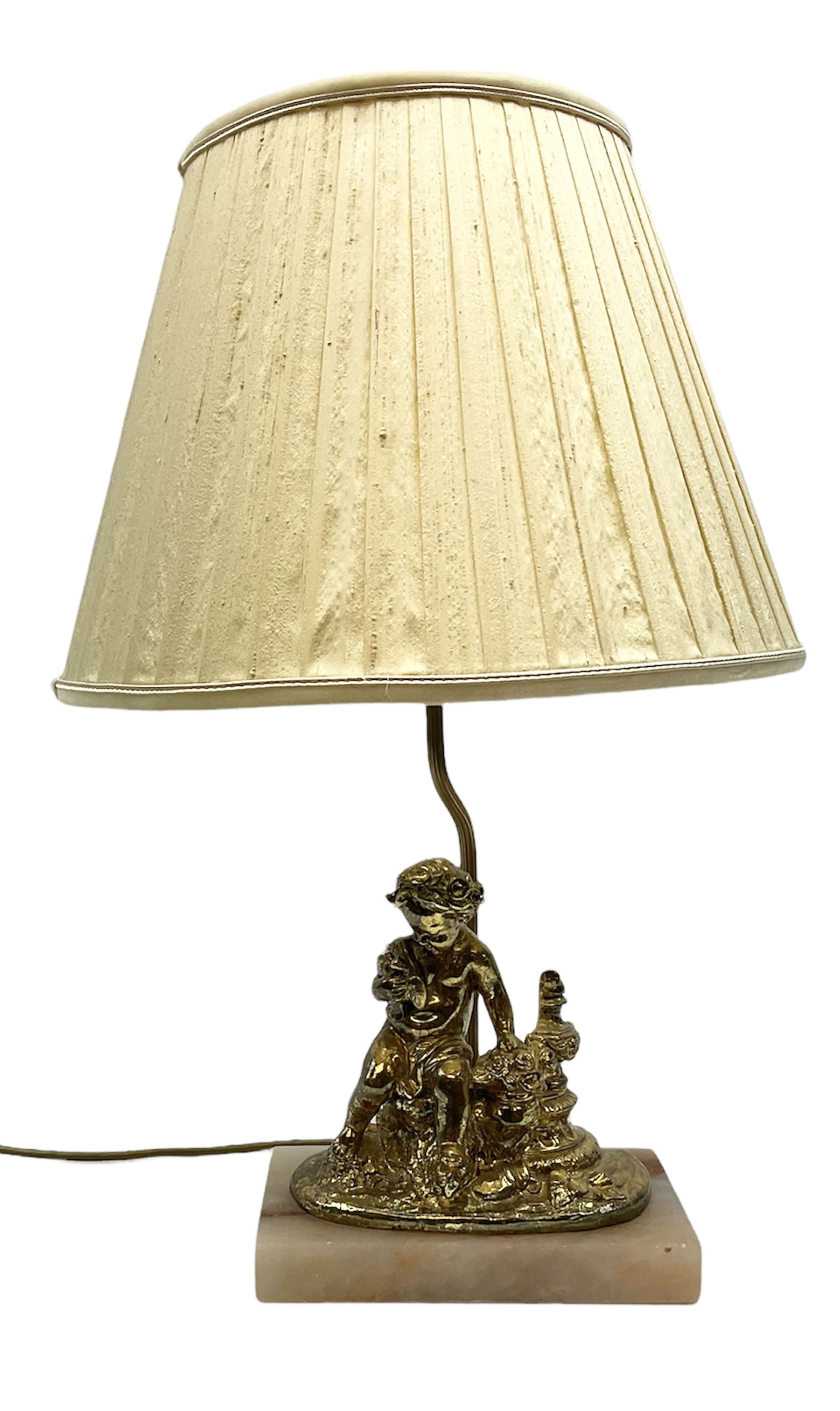 Gilt metal and onyx mounted table lamp, cast as a putti figure, H54cm ...