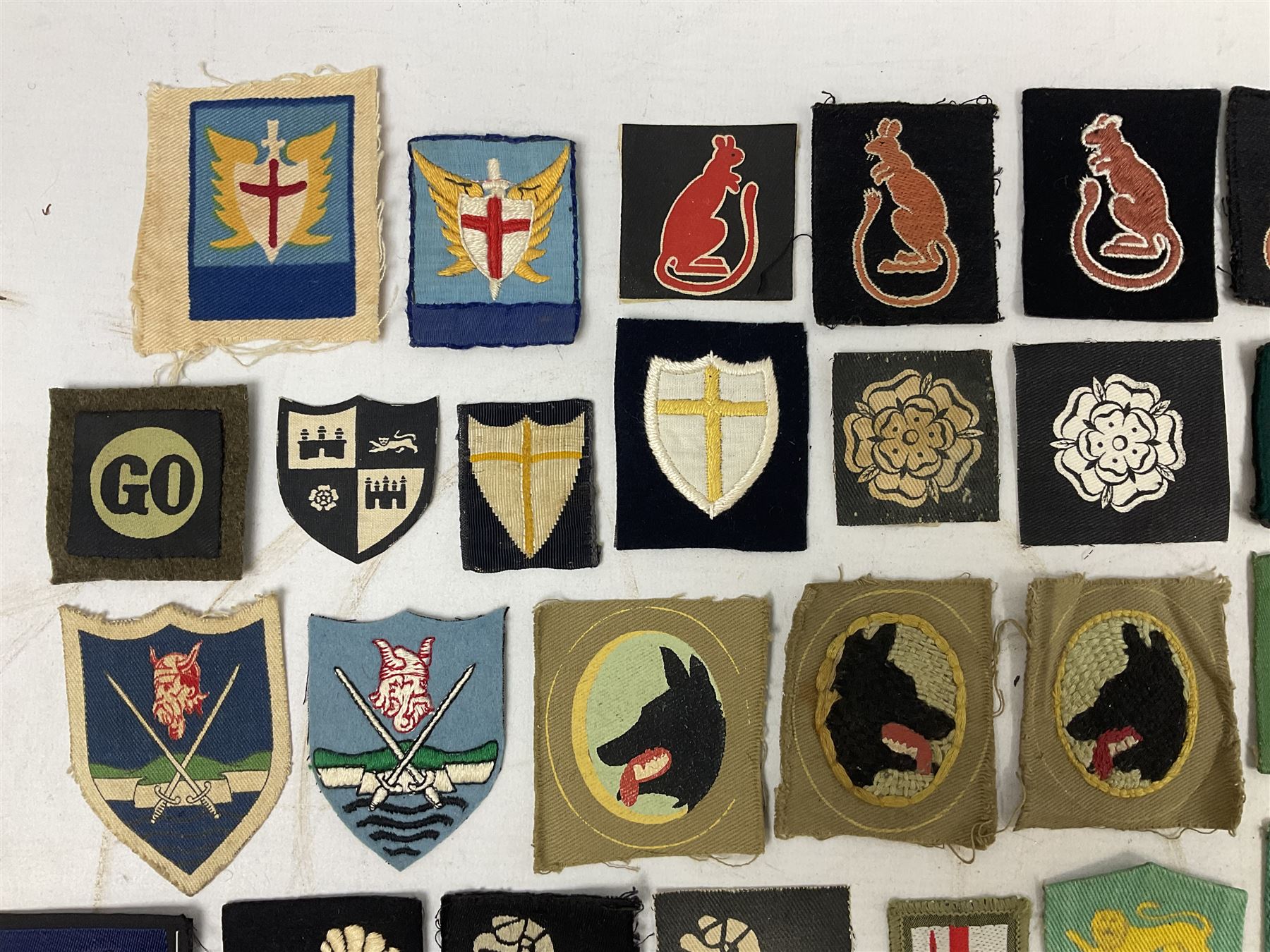 Approximately one-hundred printed and embroidered cloth badges ...