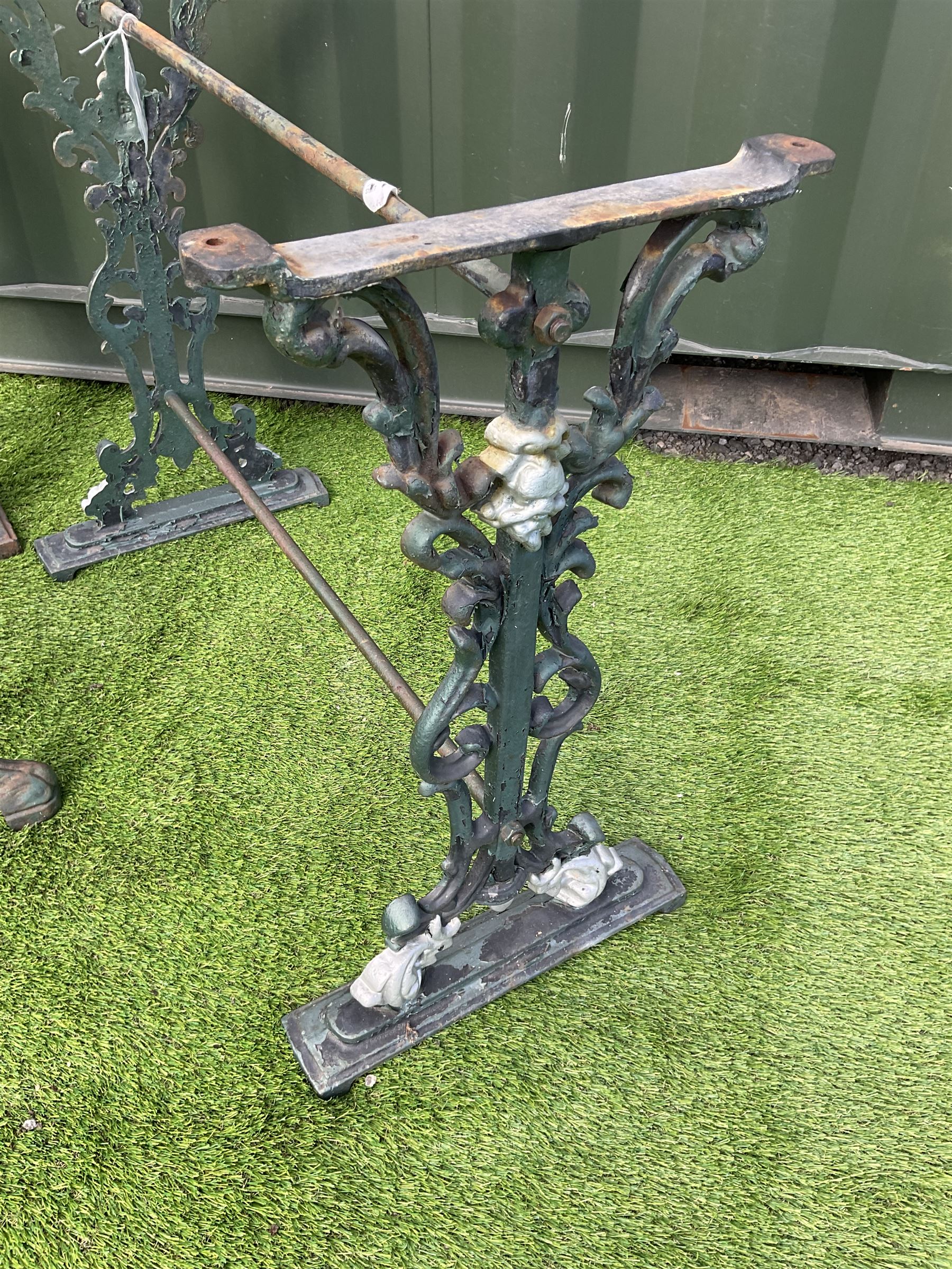 Pair of ornate cast iron table bases and one cast iron pub table base ...