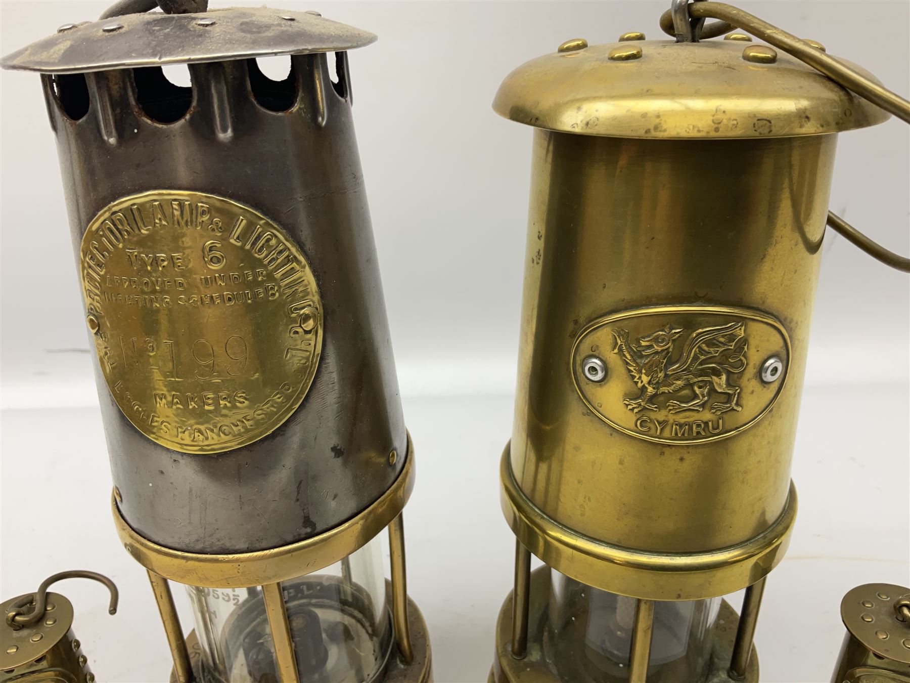 Two brass miners lamps to include an Eccles Manchester Type 6 example ...