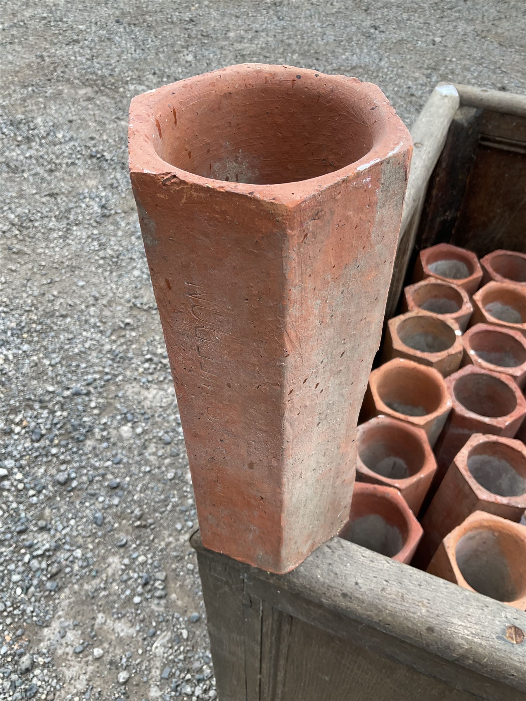 Twenty-seven terracotta land tiles formed as a pyramid shaped wine rack ...