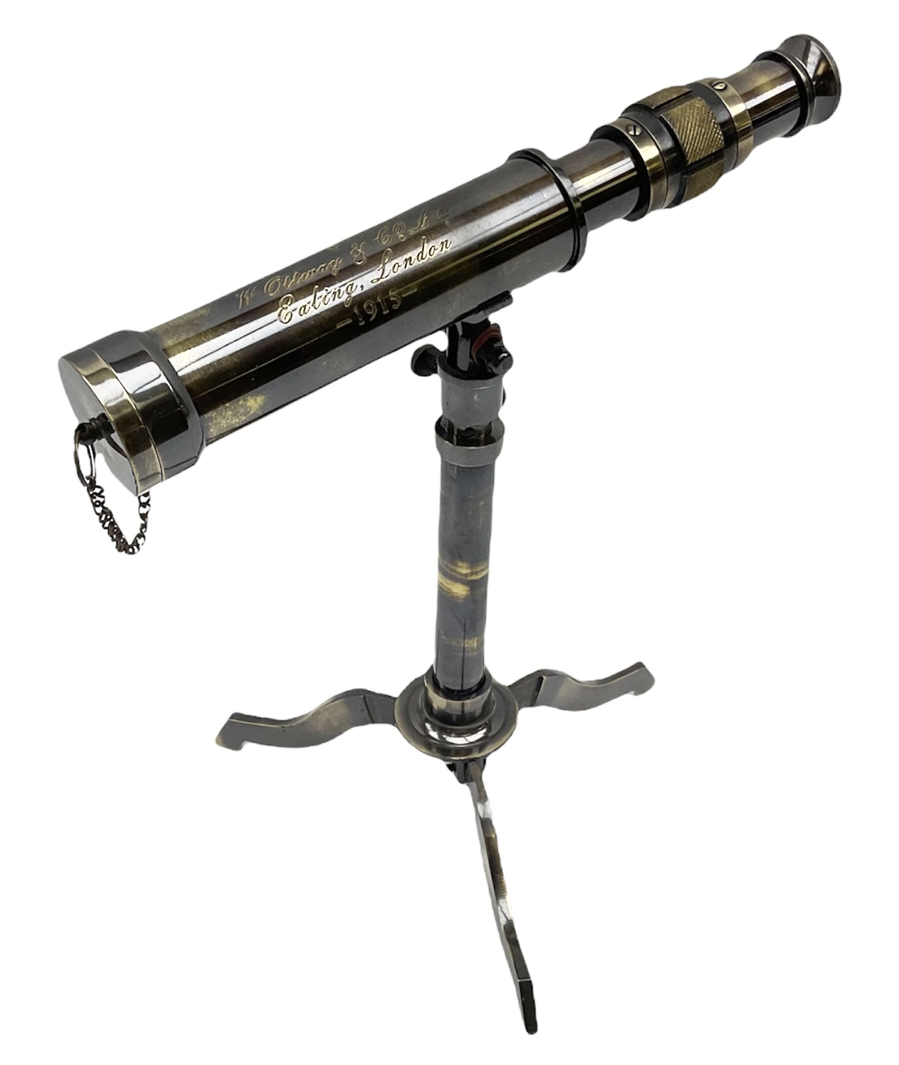 Small brass telescope mounted on an extending tripod base with folding ...