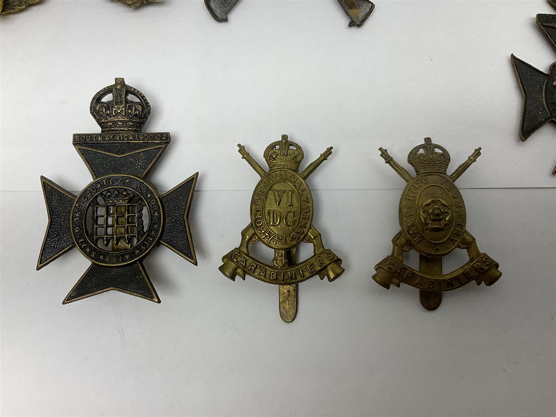 Twenty various cap badges including Rifle Brigade, Machine Gun Corps ...
