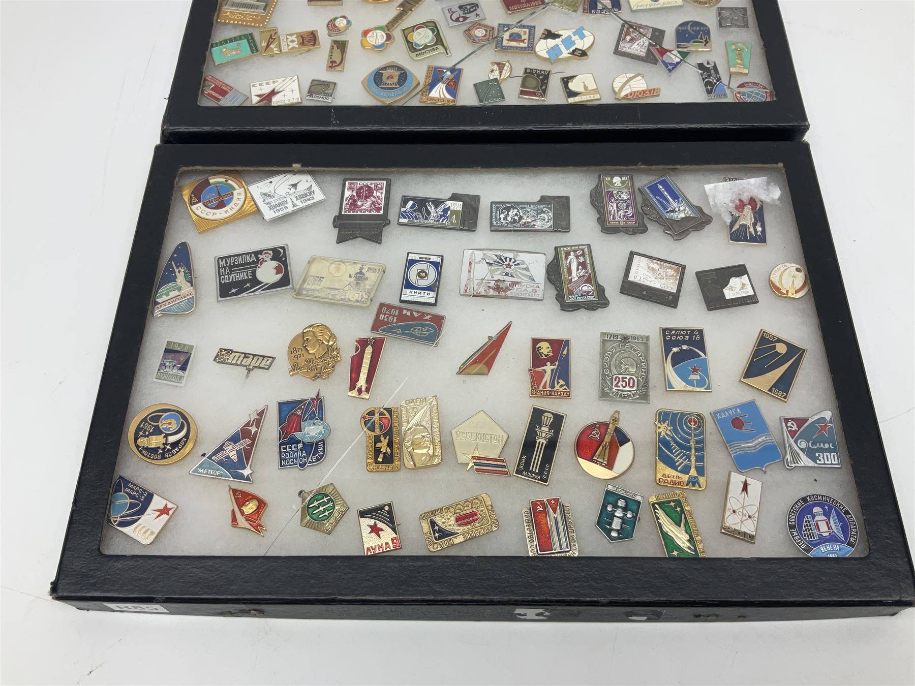 Over one hundred Soviet space programme badges; in two glass topped ...