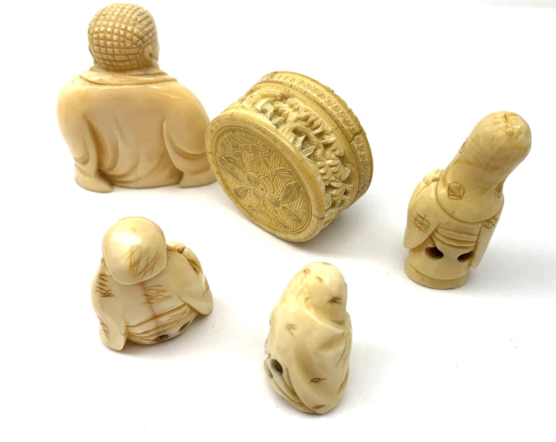 Three carved Japanese ivory netsukes modelled as three of the Lucky ...