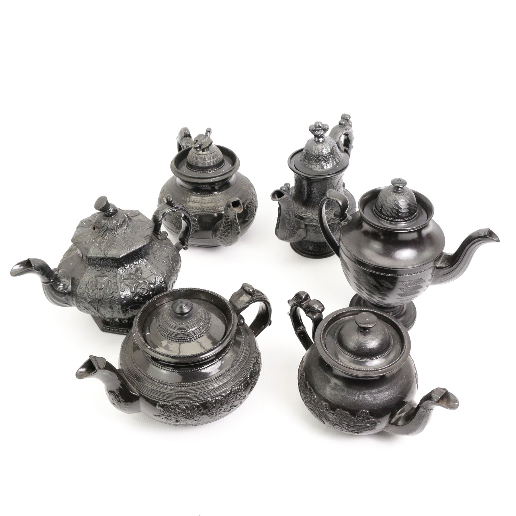 Six early 19th century and later black basalt tea and coffee pots ...