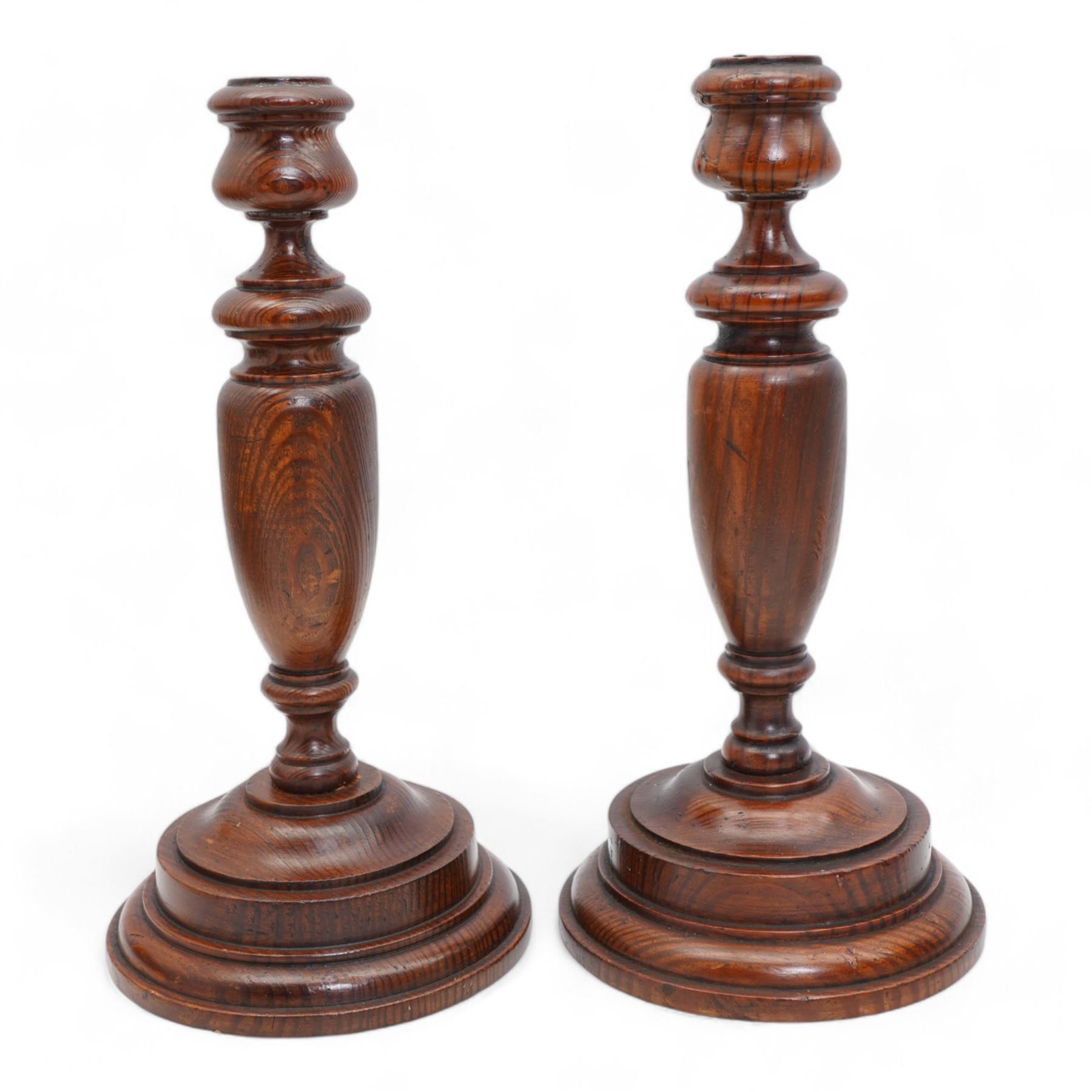 Pair of turned pine candlesticks with baluster stems, H30cm, together ...