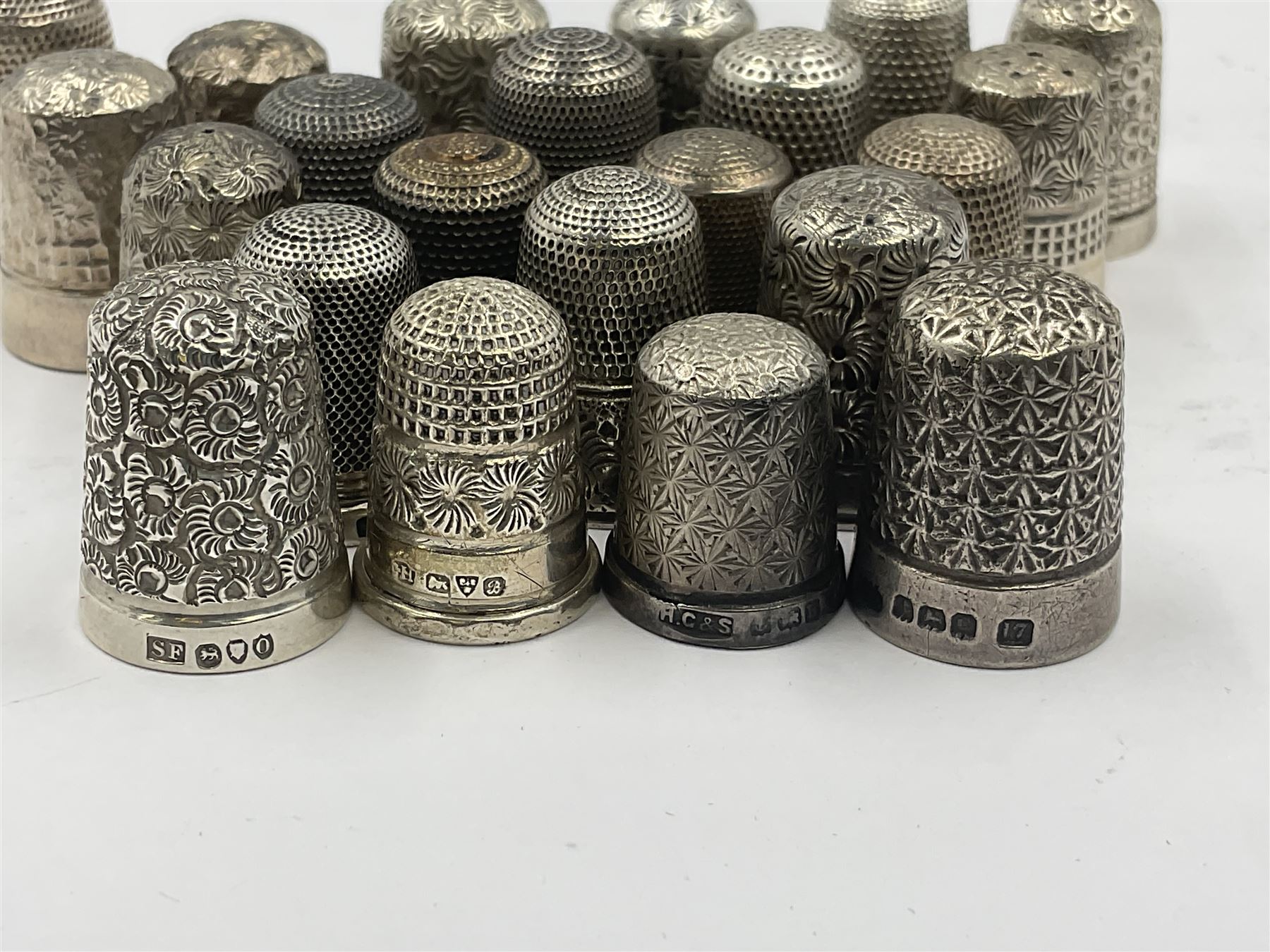 Collection of twenty-two Victorian and later silver thimbles, including five examples by Charles ...