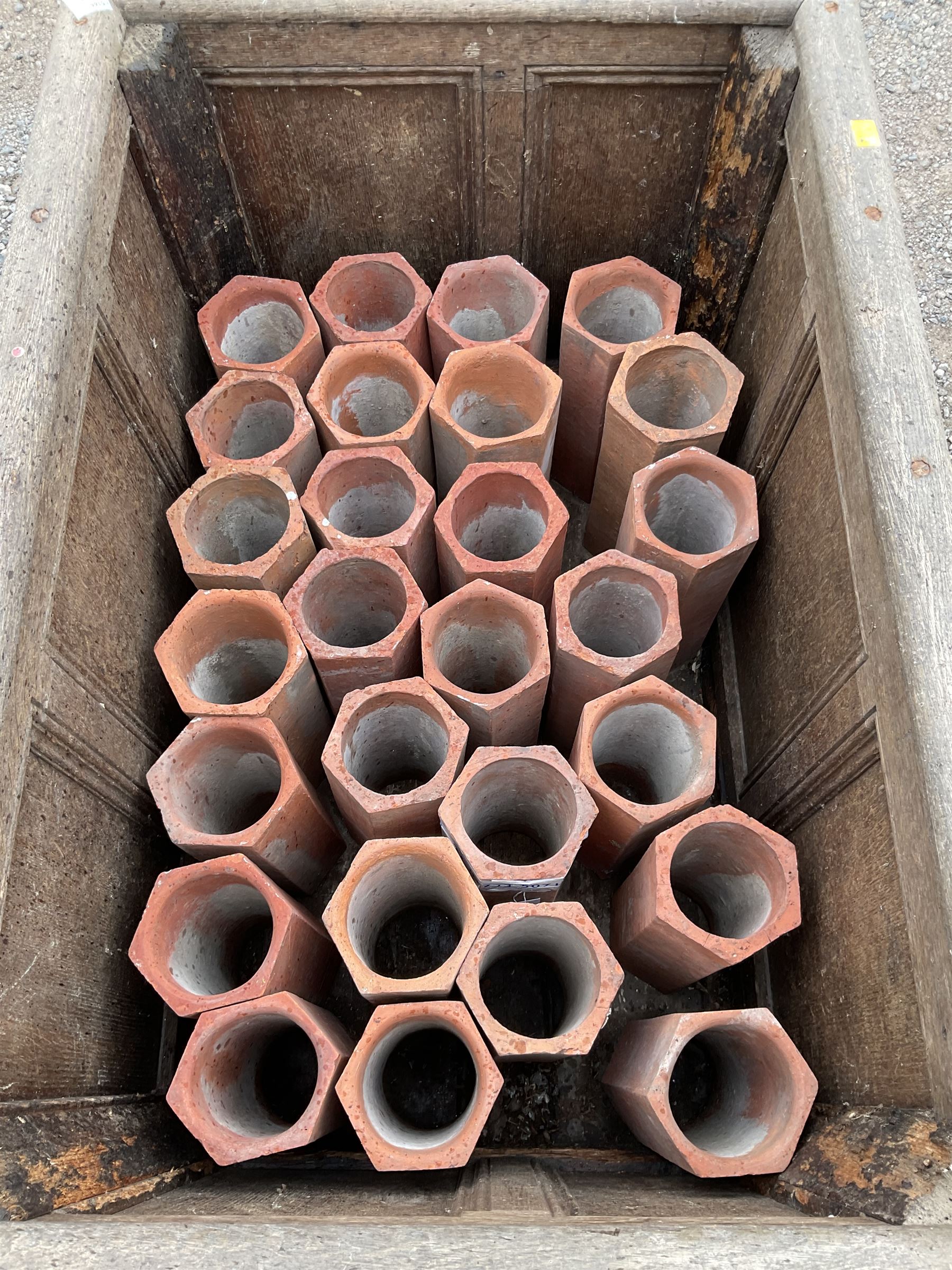Twenty-seven terracotta land tiles formed as a pyramid shaped wine rack ...