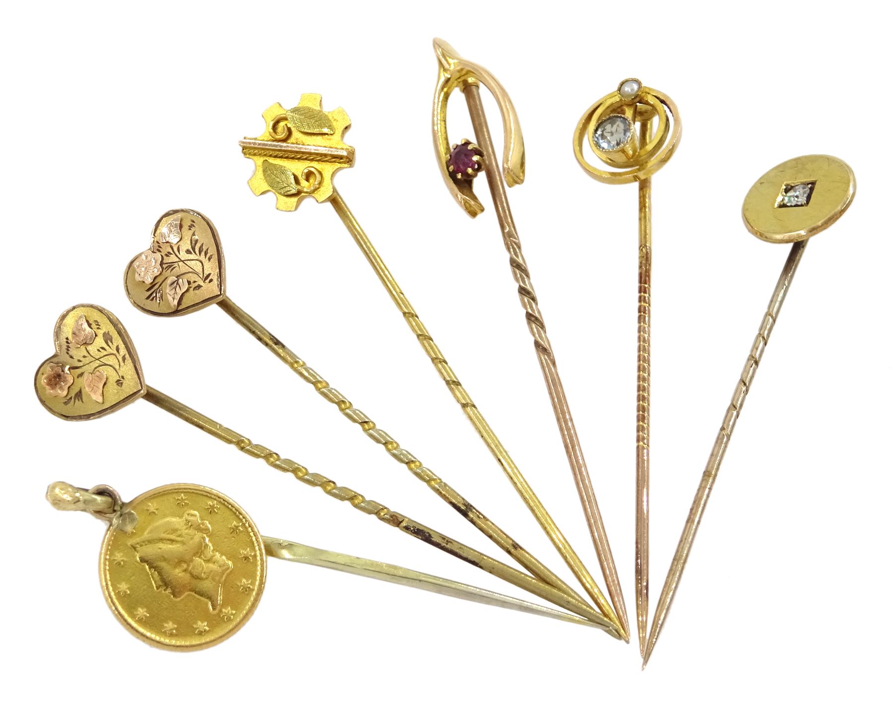 Seven Victorian and later gold stick pins including two hearts ...